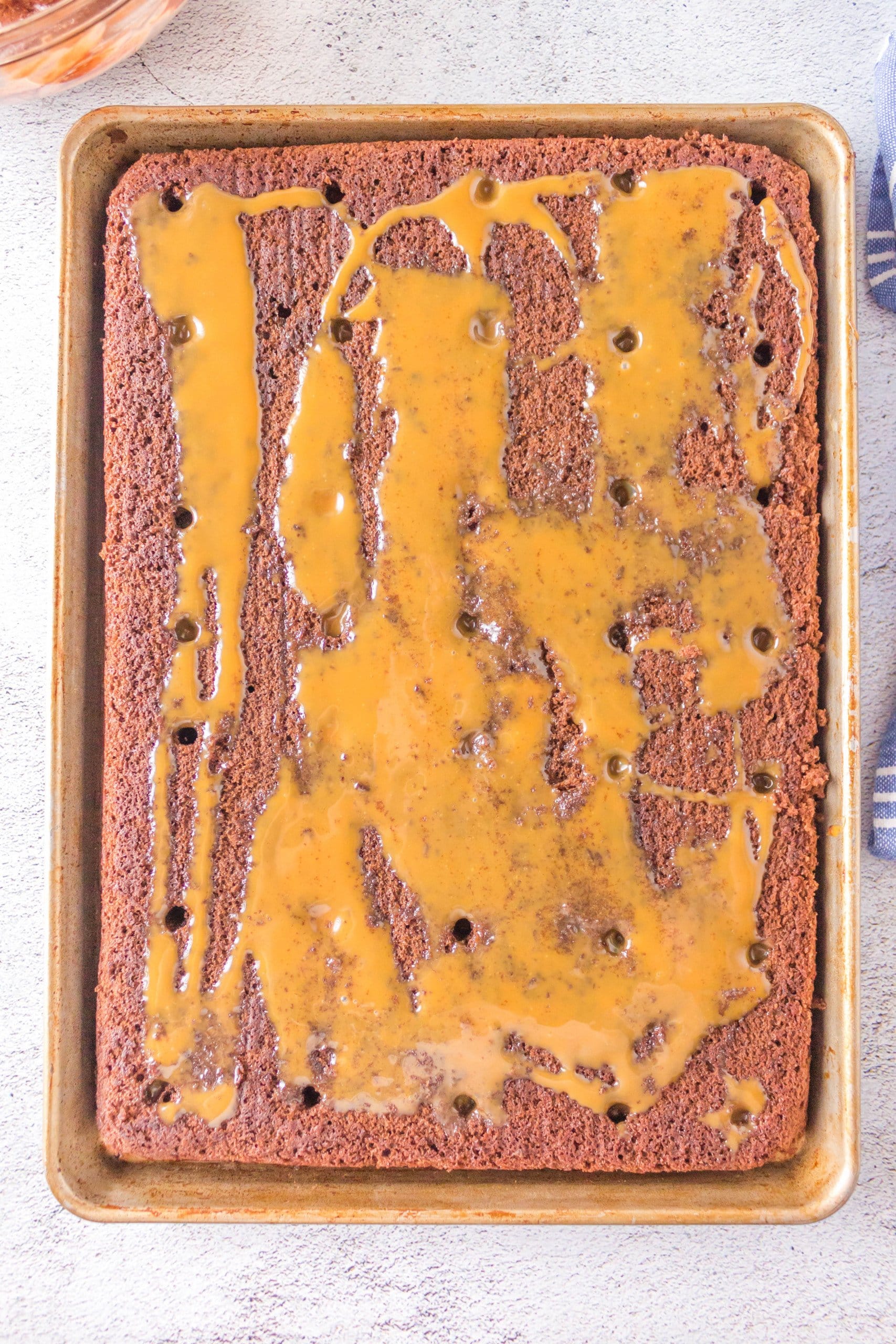 Moist Chocolate sheet pan poke cake - The Kitchen Bucket List